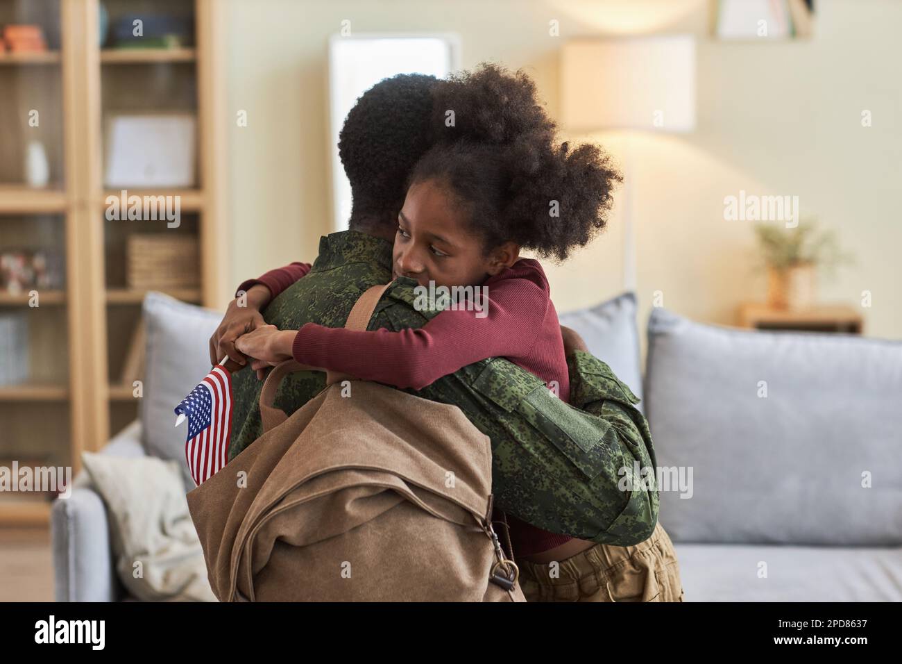 Child accompanying dad to the war, she embracing him and saying goodbye ...