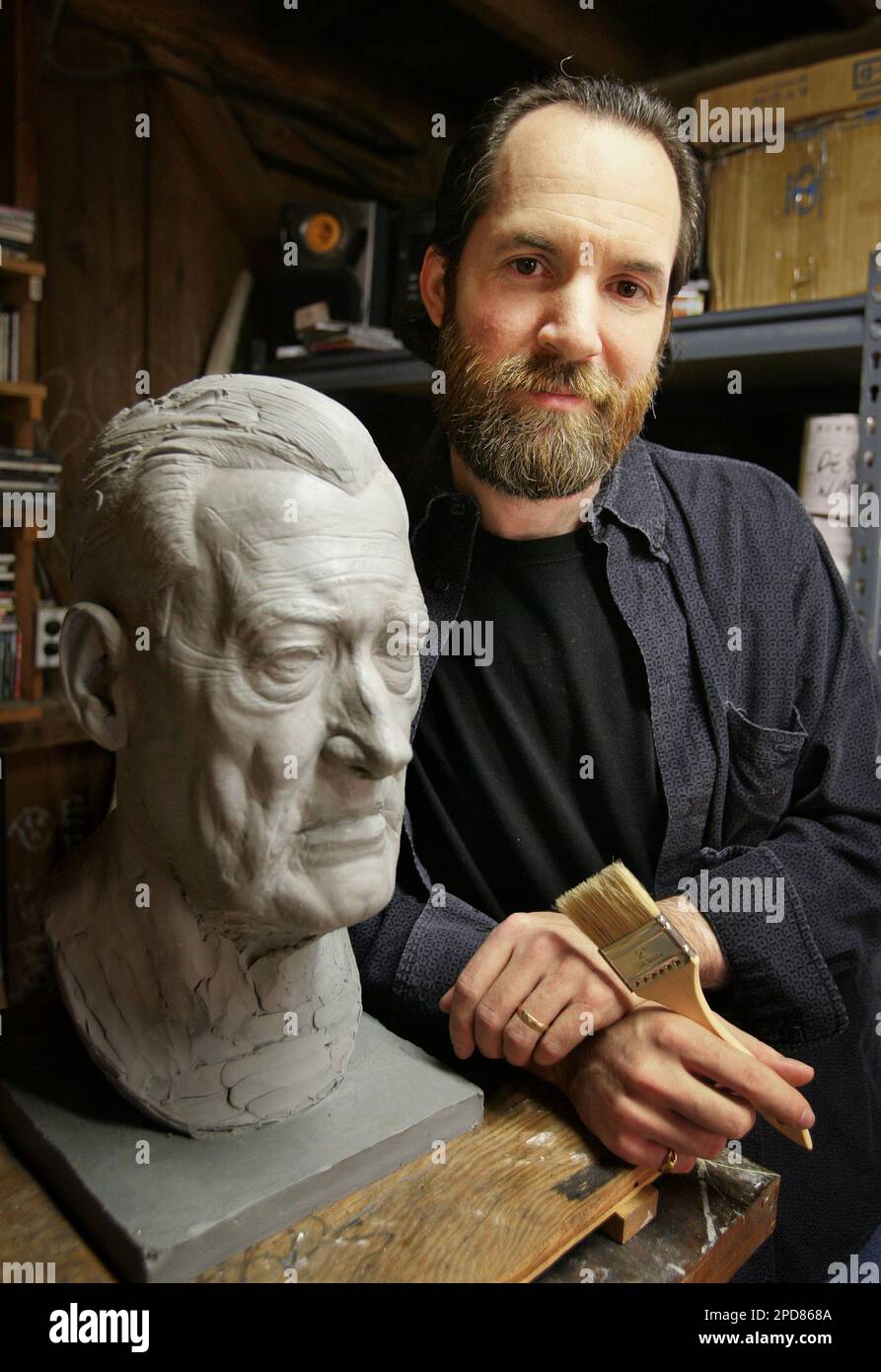 Sculptor Daniel Edwards stands next to a 2005 portrait he created of ...