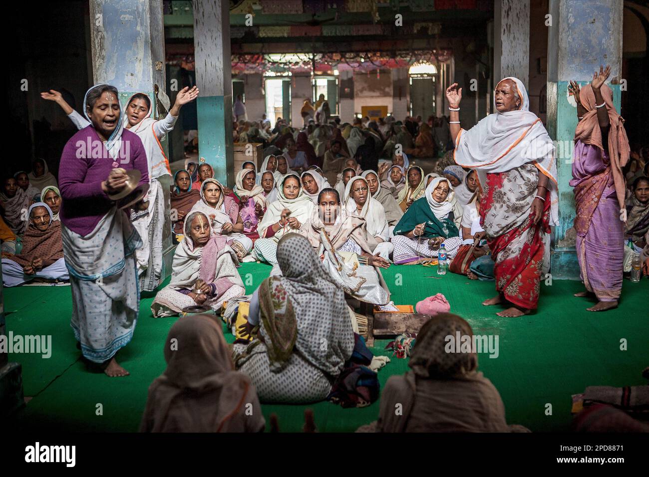 Widows praying in a Bhajan ashram, Vrindavan, Mathura district, India ...