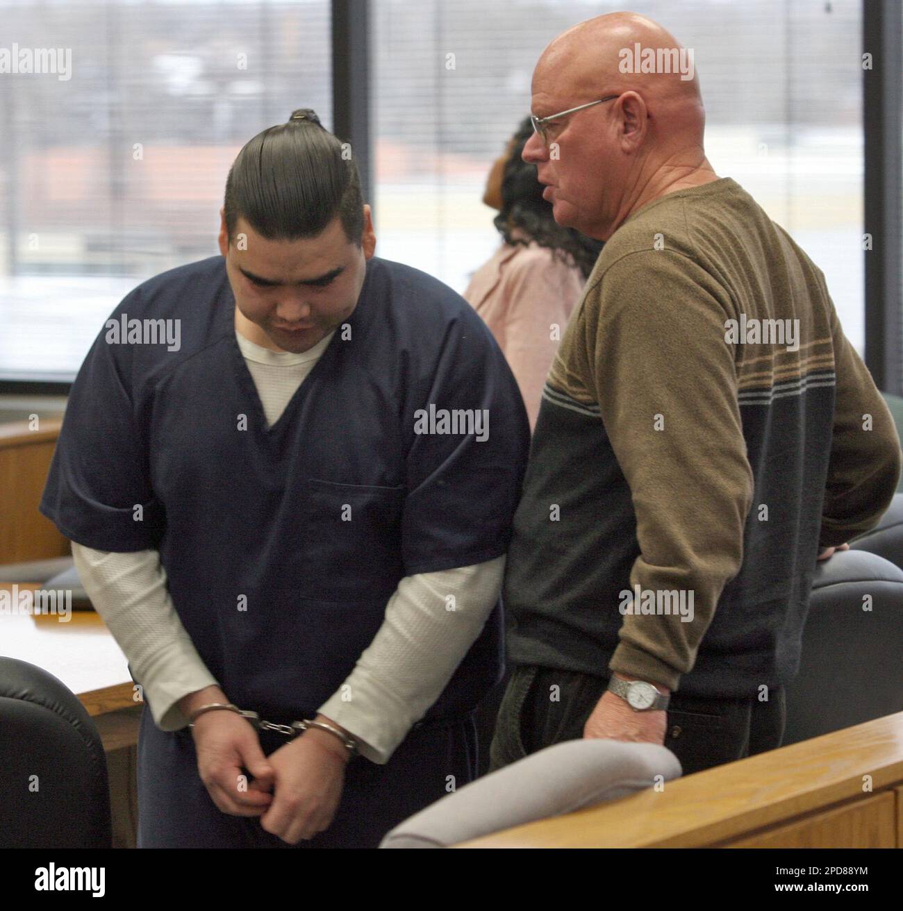 Jamie Velasco, left, walks past defense team member Bruse Whitman as he ...