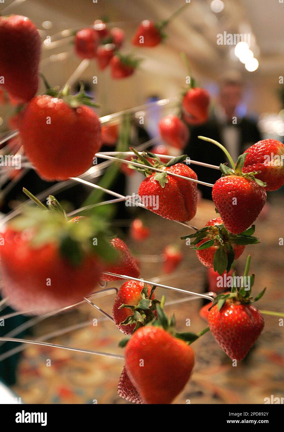 Wire trees adorned with strawberries are seen in the pastry section of ...