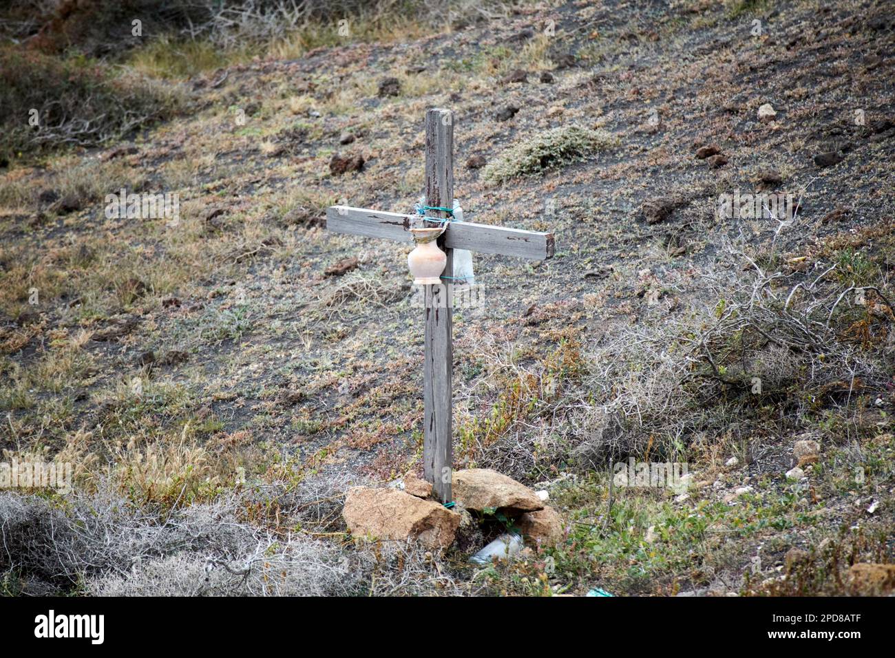 wooden cross and offerings by the roadside on a remore rural mountain ...