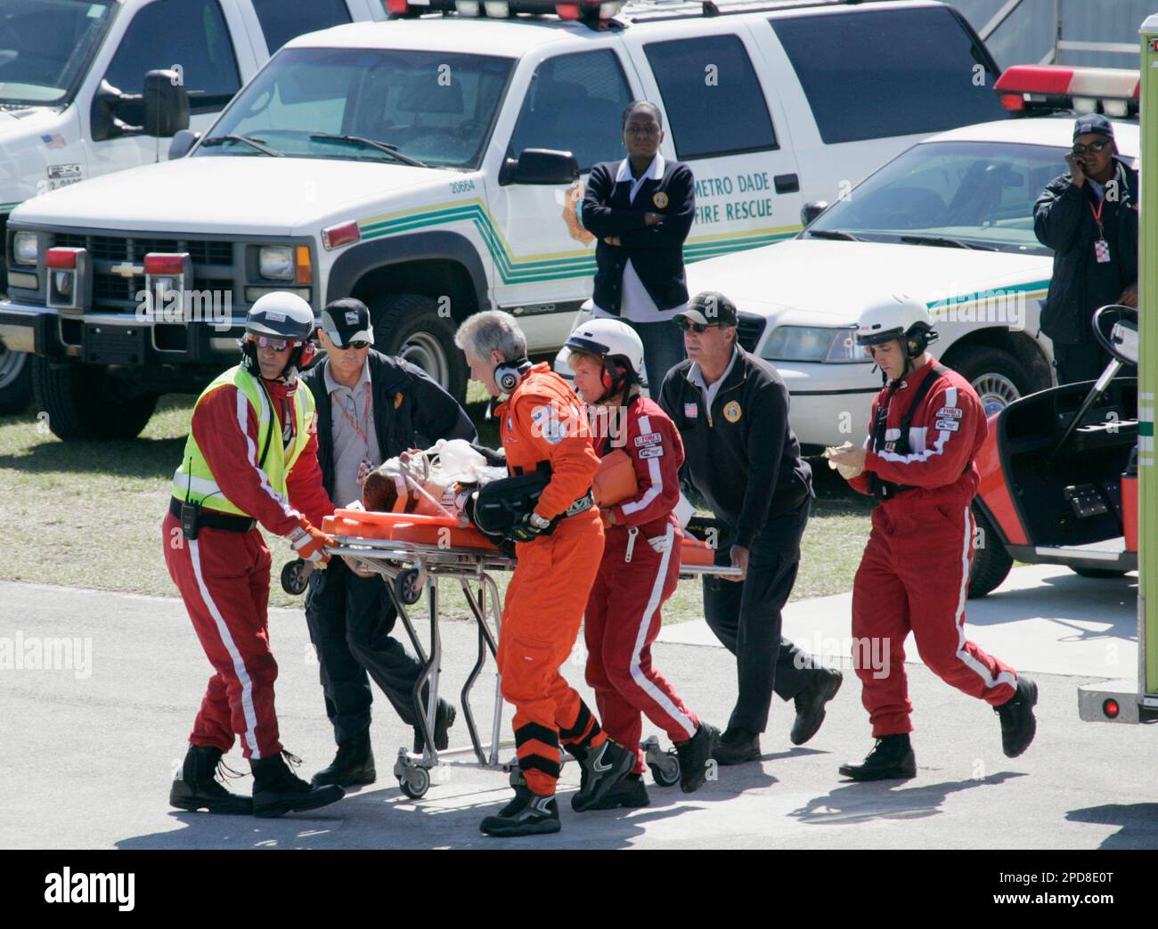 Medical personal carry IndyCar driver Paul Dana to a rescue helicopter ...