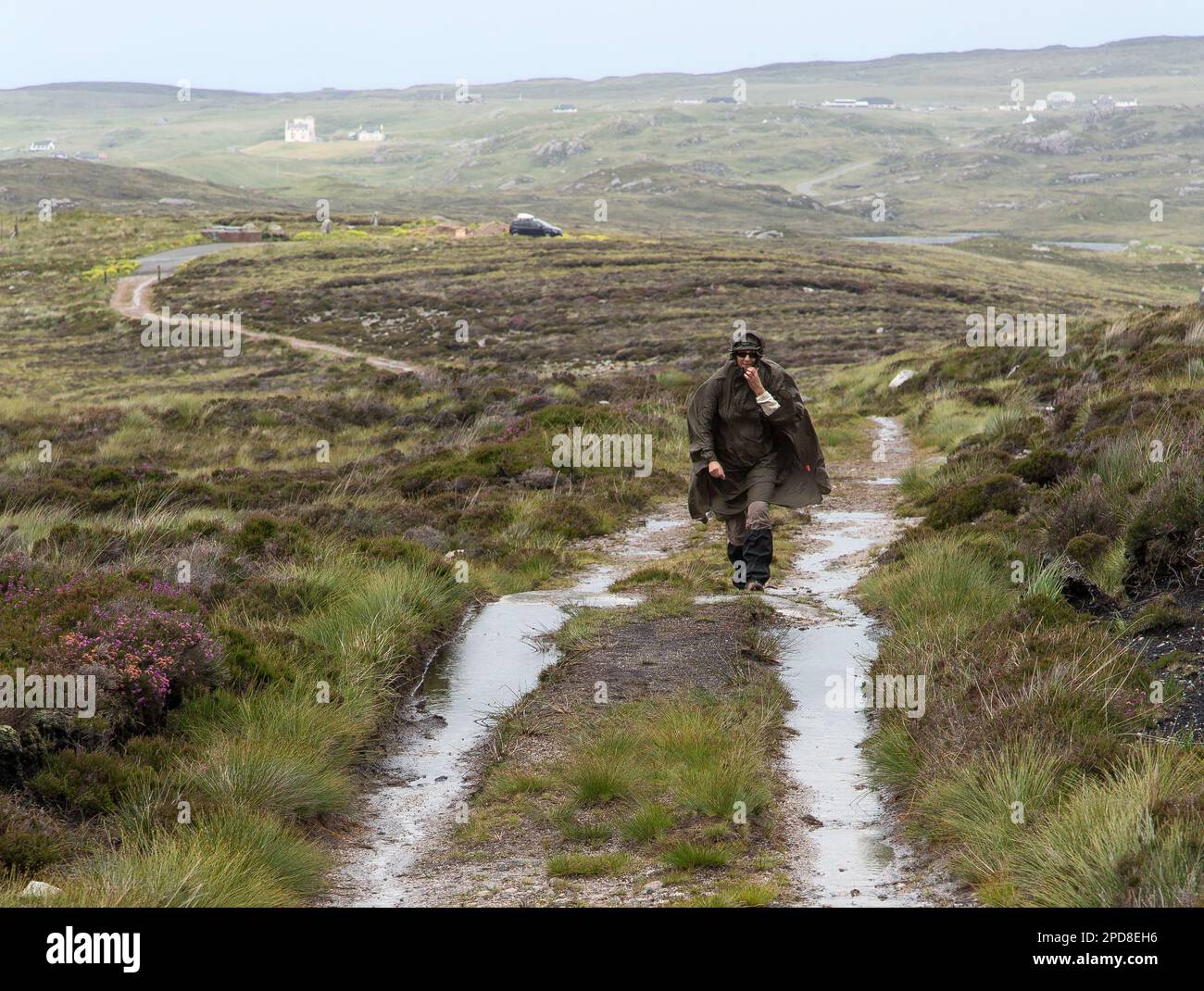 Female Walker in Rain Poncho in the Highlands near Loch Suaineabhal ...