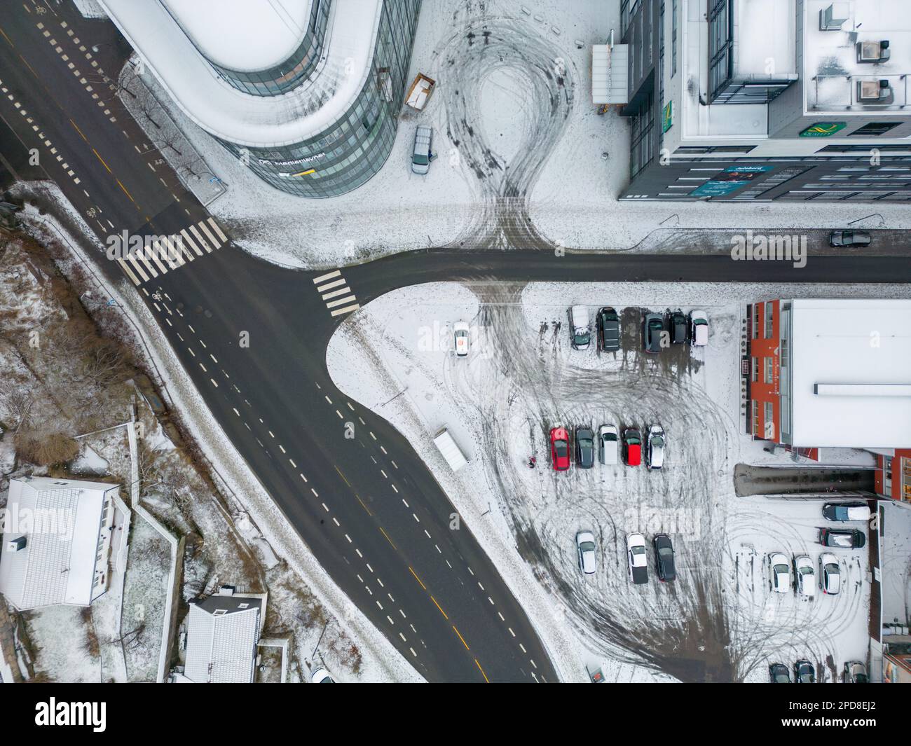 Aerial view of city street surrounded by buildings covered in snow in ...