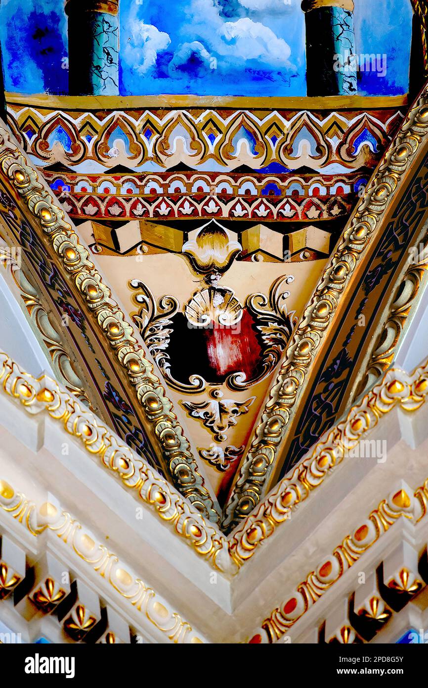 The ceiling showcases an intricate ornate design in vivid shades of ...