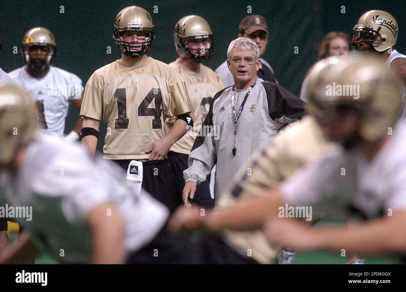 Idaho football coach Dennis Erickson, right, talks to punter T. J ...