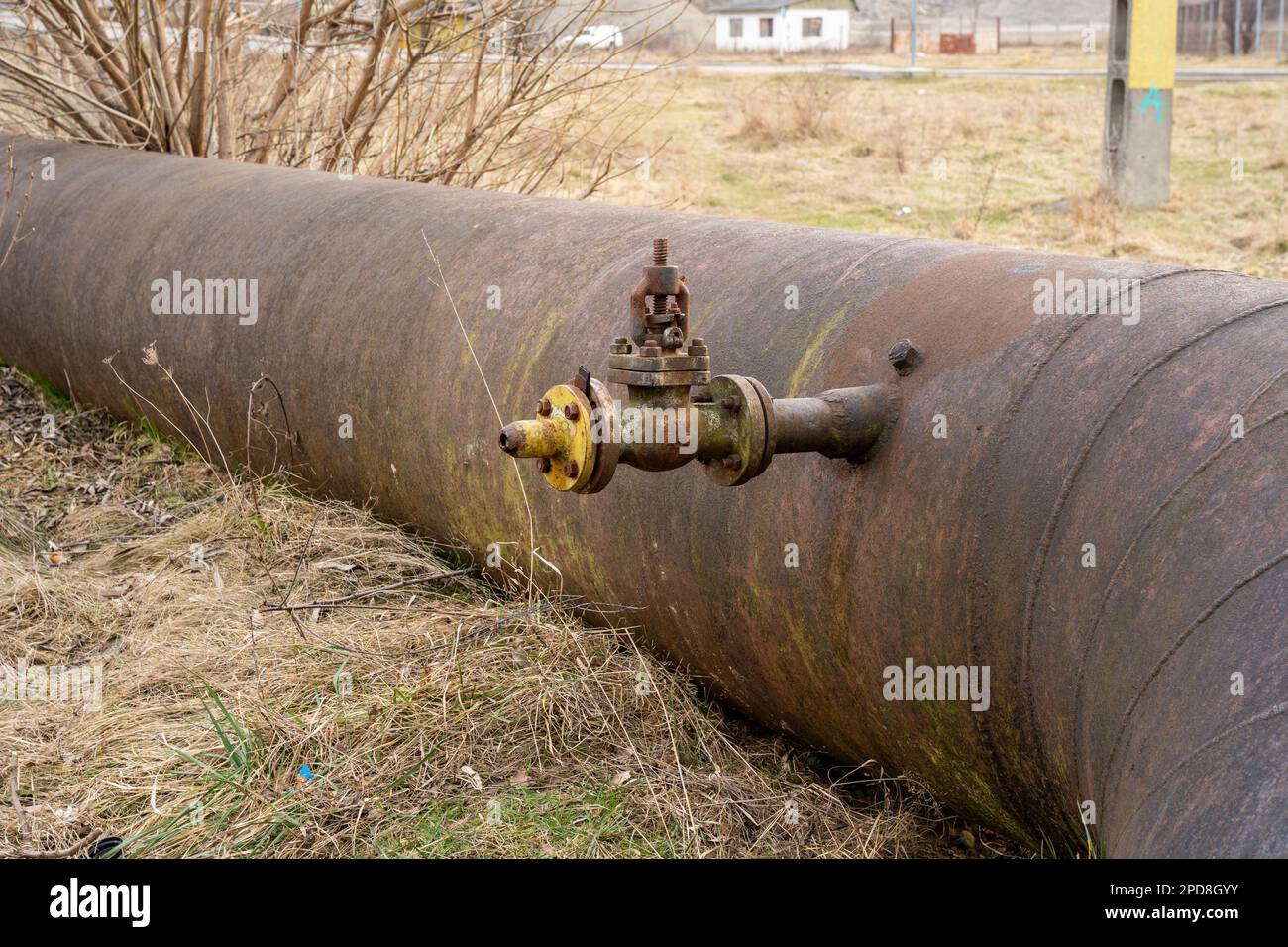A vintage meter attached to a metal pipe on the ground Stock Photo - Alamy
