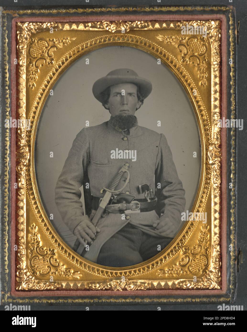 Unidentified soldier in Confederate uniform with sword and two guns ...