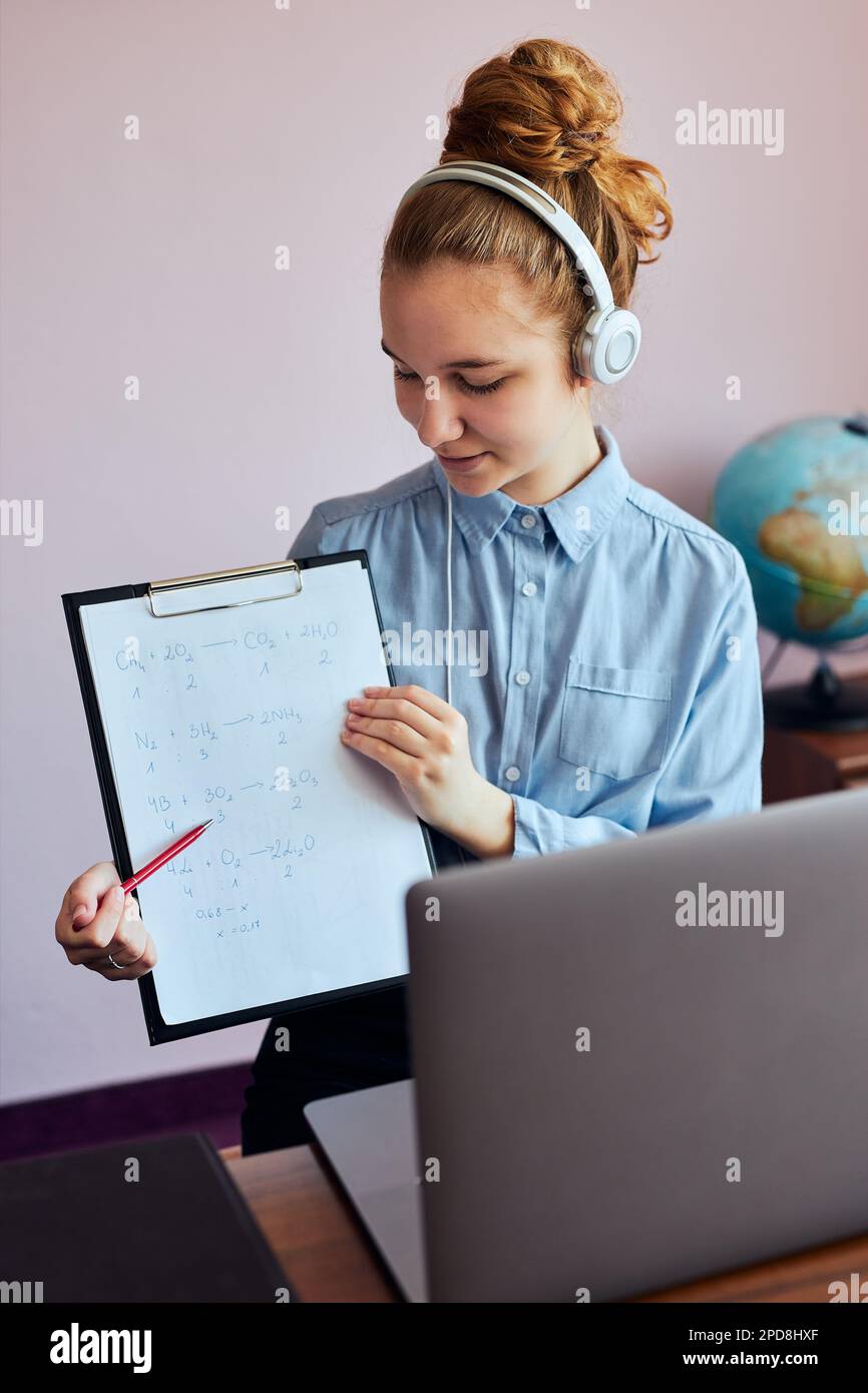 Young woman student showing homework, having classes, learning online ...