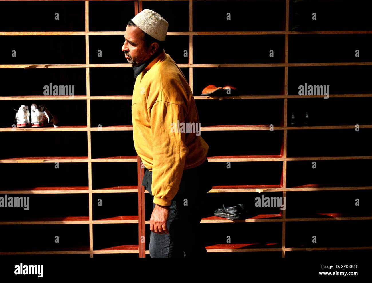 A muslim man gets his shoes after his prayers in Omeriye mosque, after ...