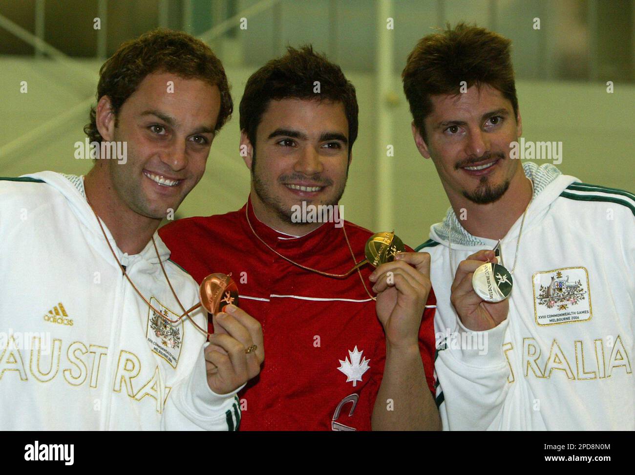 Gold medal winner Alexandre Despatie, center, of Canada, celebrates ...