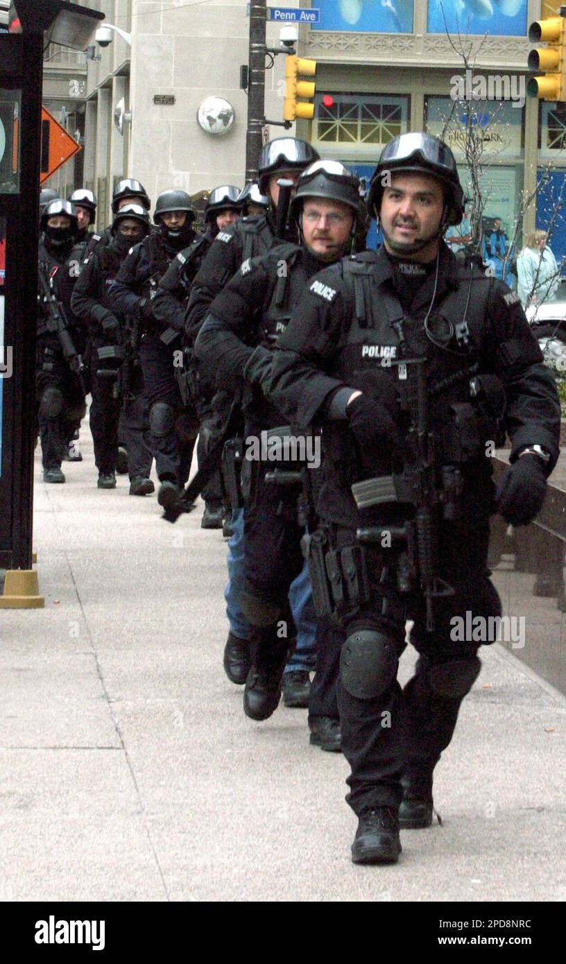Members of a Pittsburgh SWAT team walk down Stanwix Street, Wednesday ...