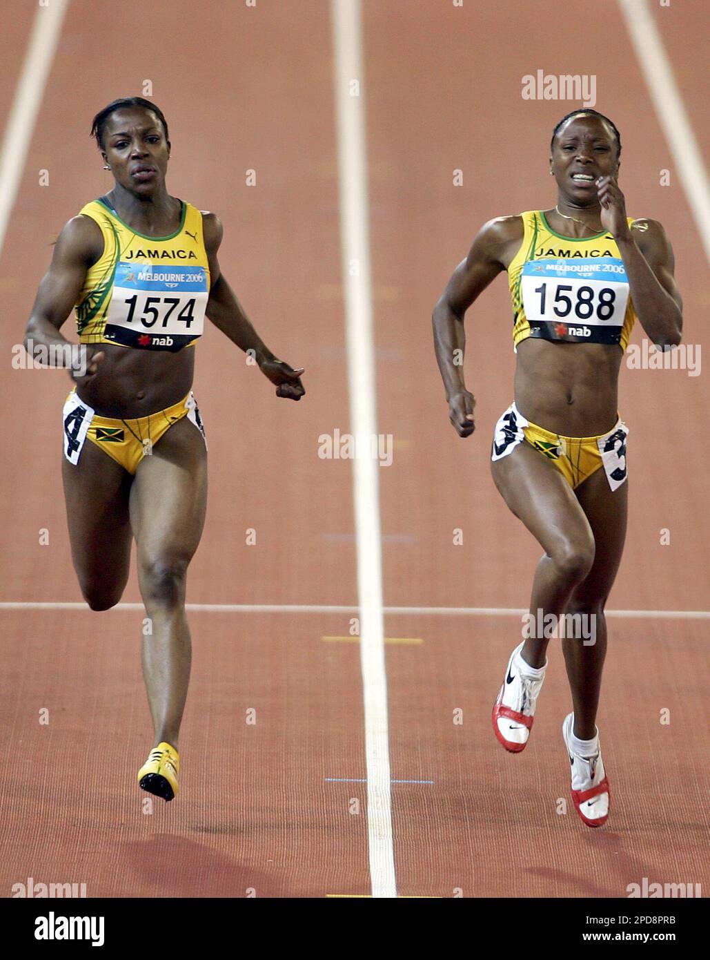 Jamaica's Sherone Simpson, right, races to the finish line to win the ...
