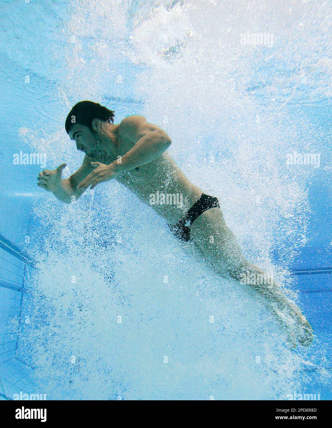 Canadian diver Alexandre Despatie swims to the surface after making a ...