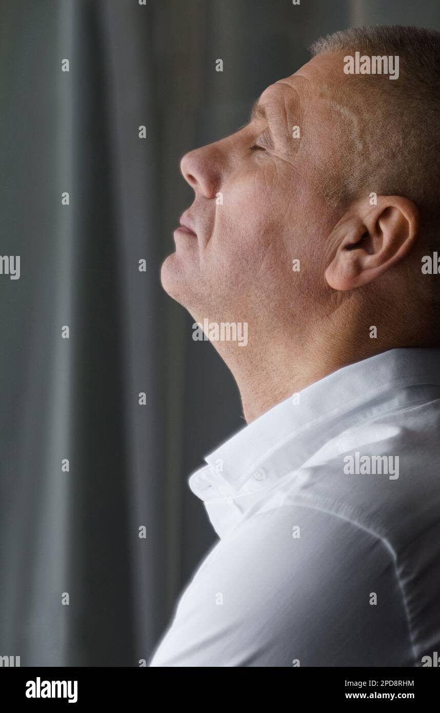Portrait of a male businessman who stands near the window raised his ...