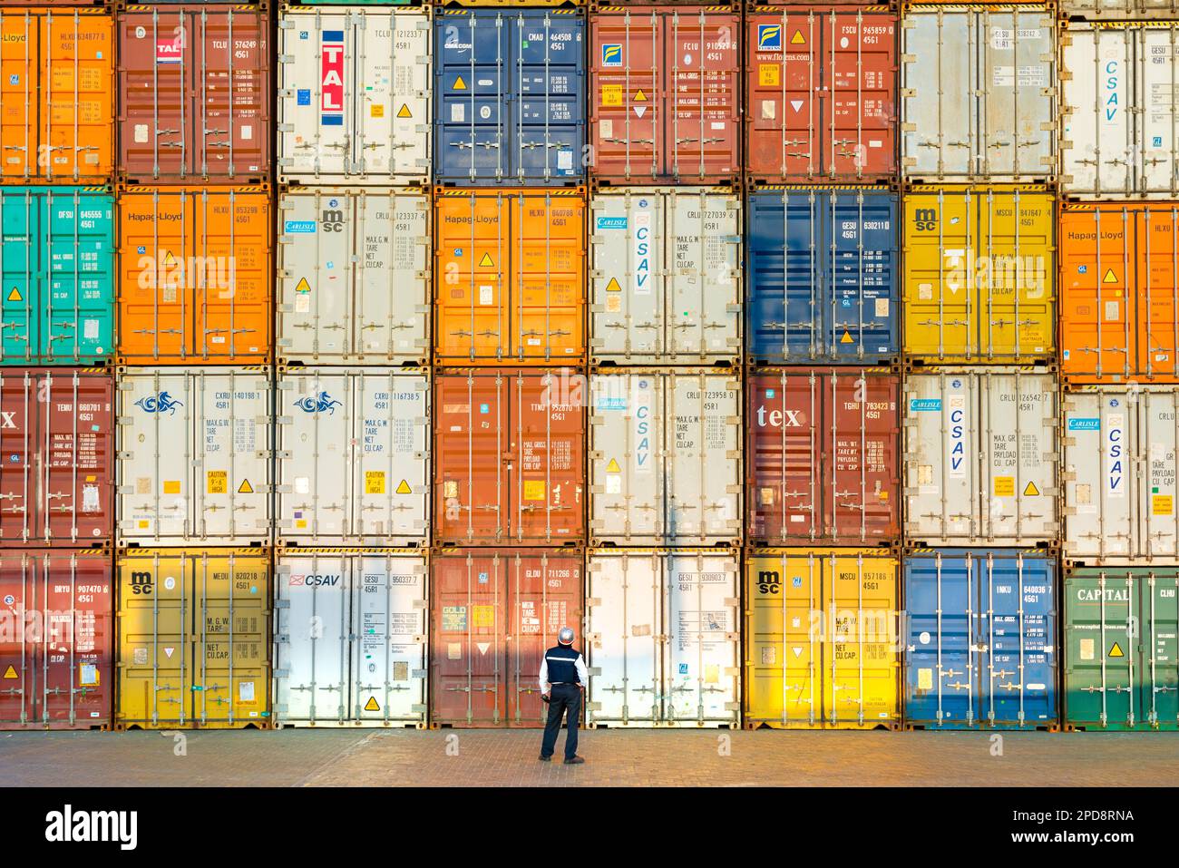 Iquique, Tarapaca Region, Chile - A port worker looking at a stack of ...
