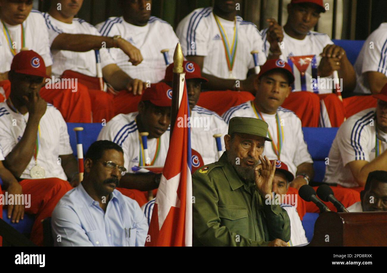 Cuban President Fidel Castro addresses the crowd as baseball players ...