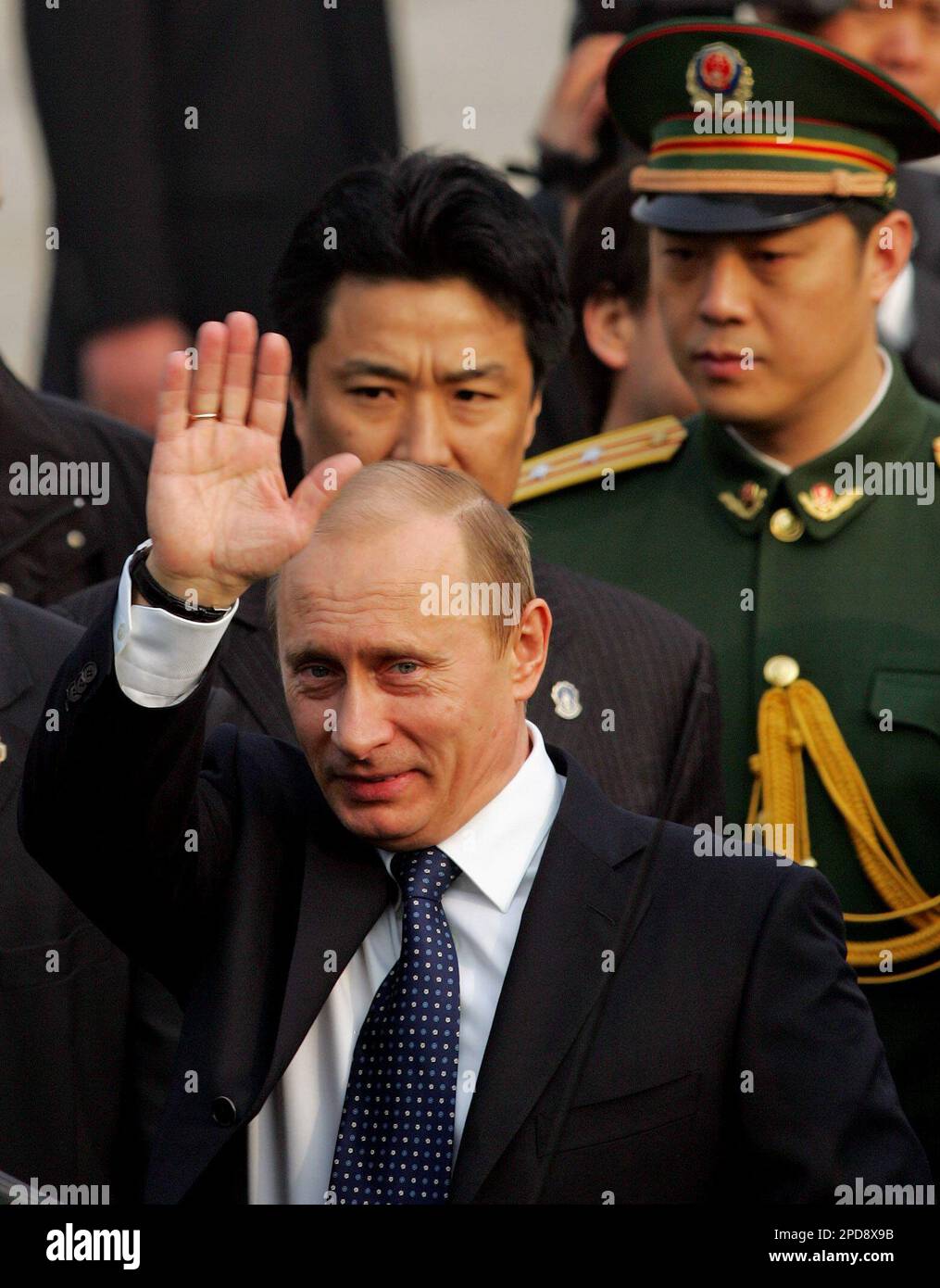 Russian President Vladimir Putin waves as he arrives at Beijing airport ...