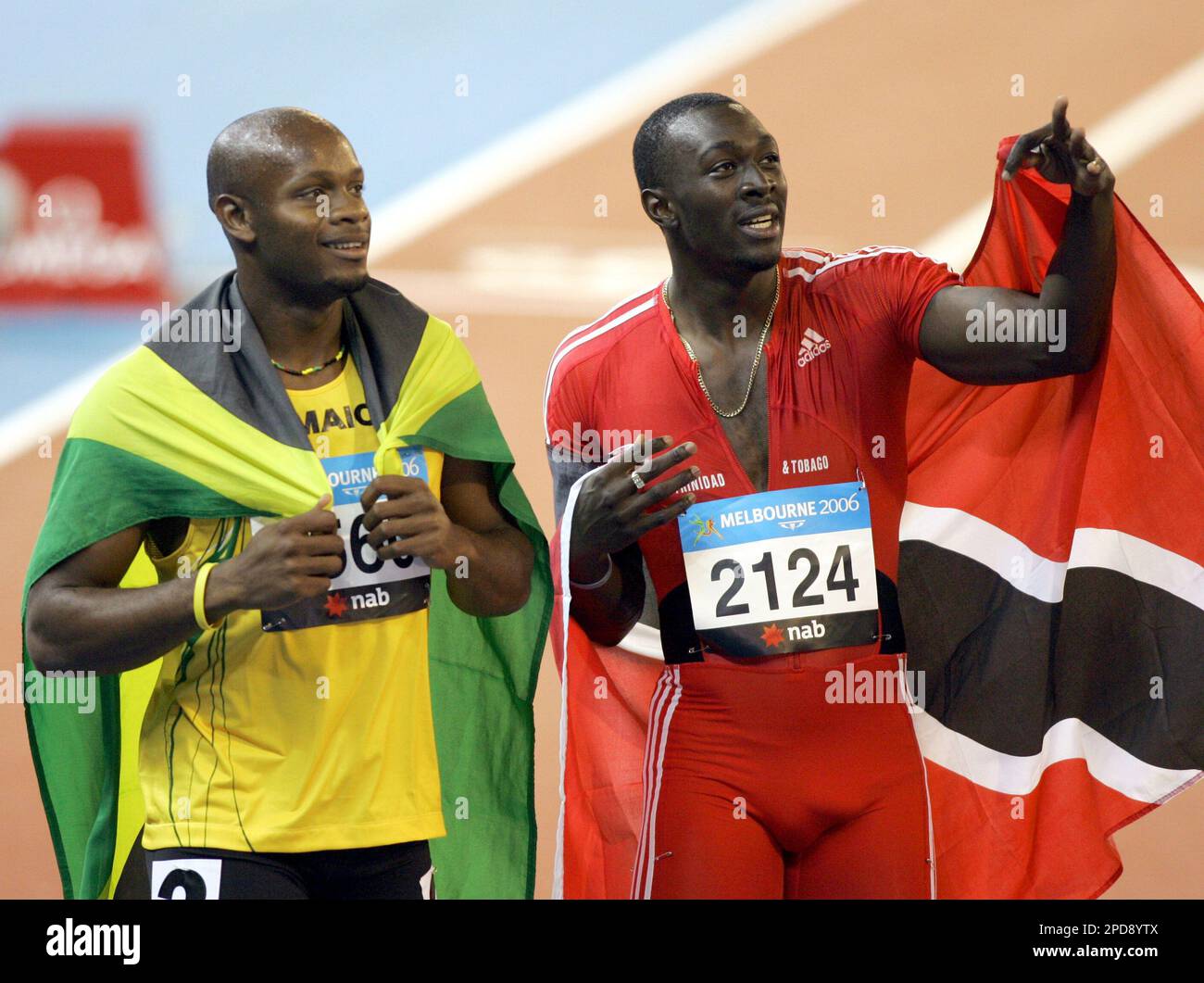 Asafa Powell of Jamaica, left, the gold medalist and Marc Burns of ...