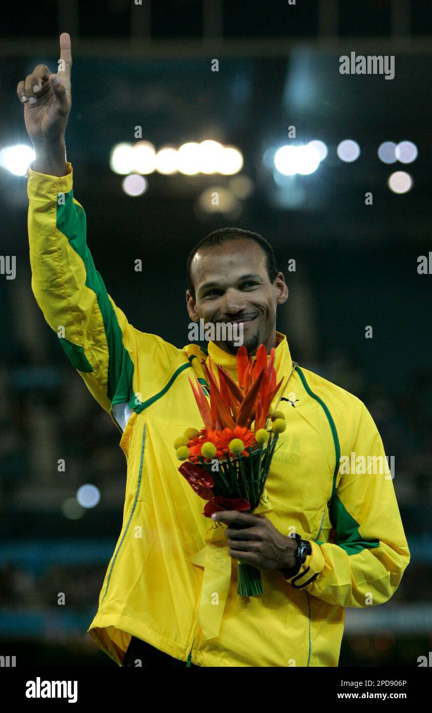 Jamaica's Maurice Wignall waves during the medal ceremony after winning ...