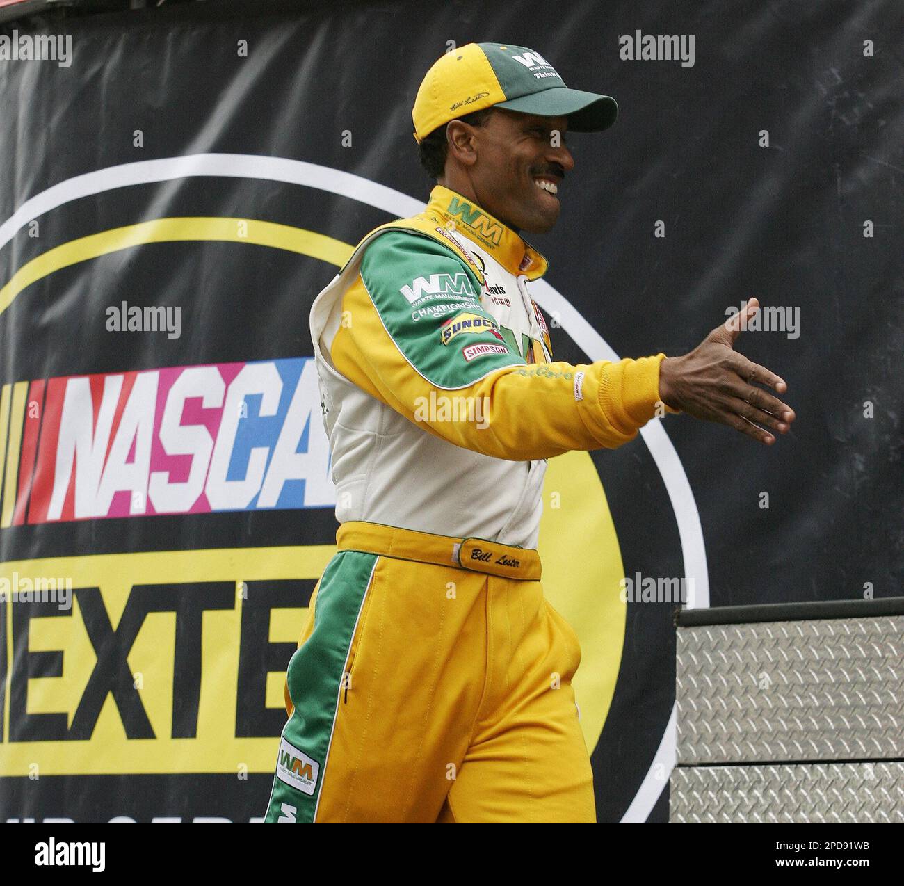 NASCAR driver Bill Lester walks past the NASCAR logo as he is ...