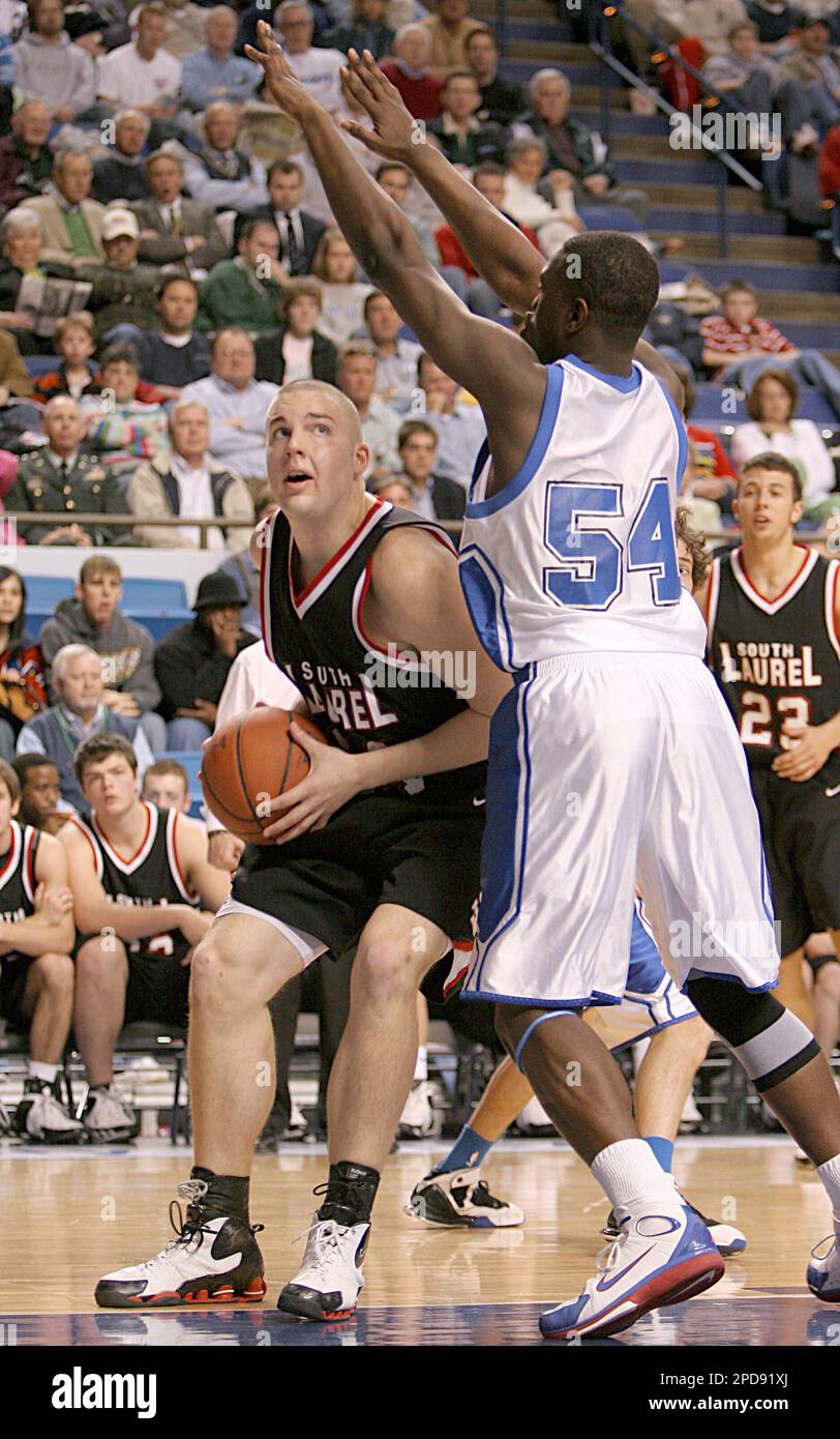 South Laurel's Walt Allen, left, goes under the arms of Graves County ...