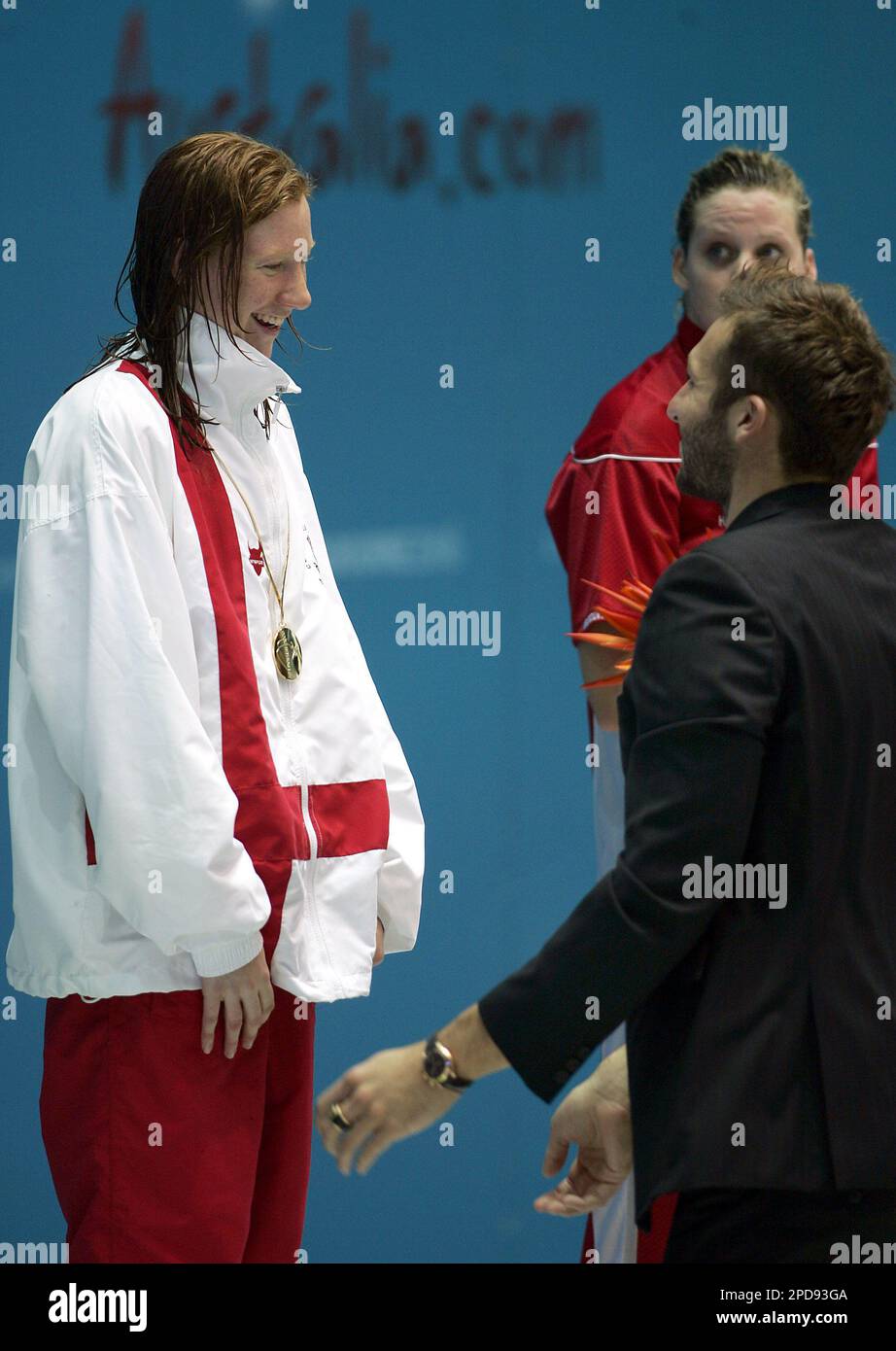 England's Rebecca Cooke smiles after receiving her gold medal for the ...
