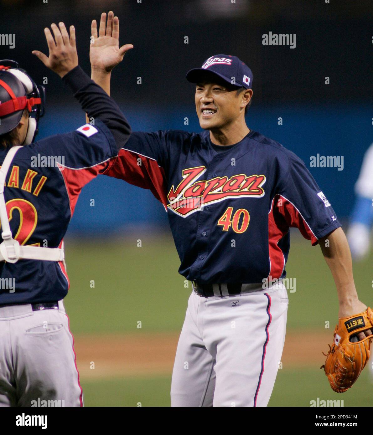 Japan's closing pitcher Akinori Otsuka is congratulated by catcher ...