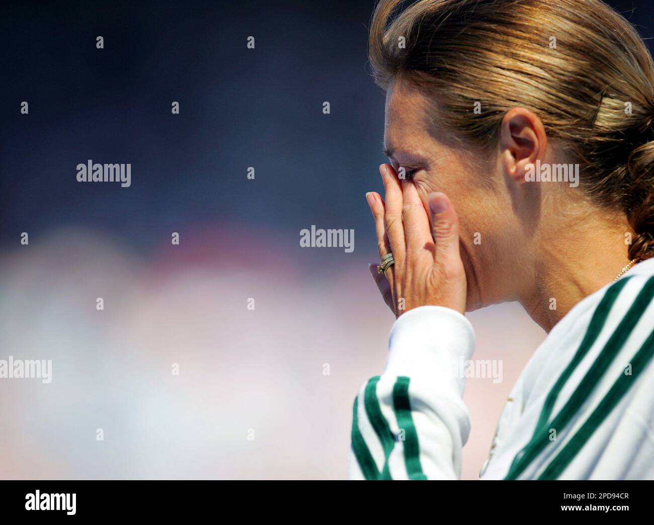 Australia's Kerryn McCann wipes her eye after receiving the gold medal ...