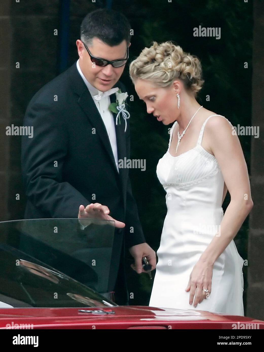 Rusty Yates opens the car door for his new bride Laura Arnold as they ...