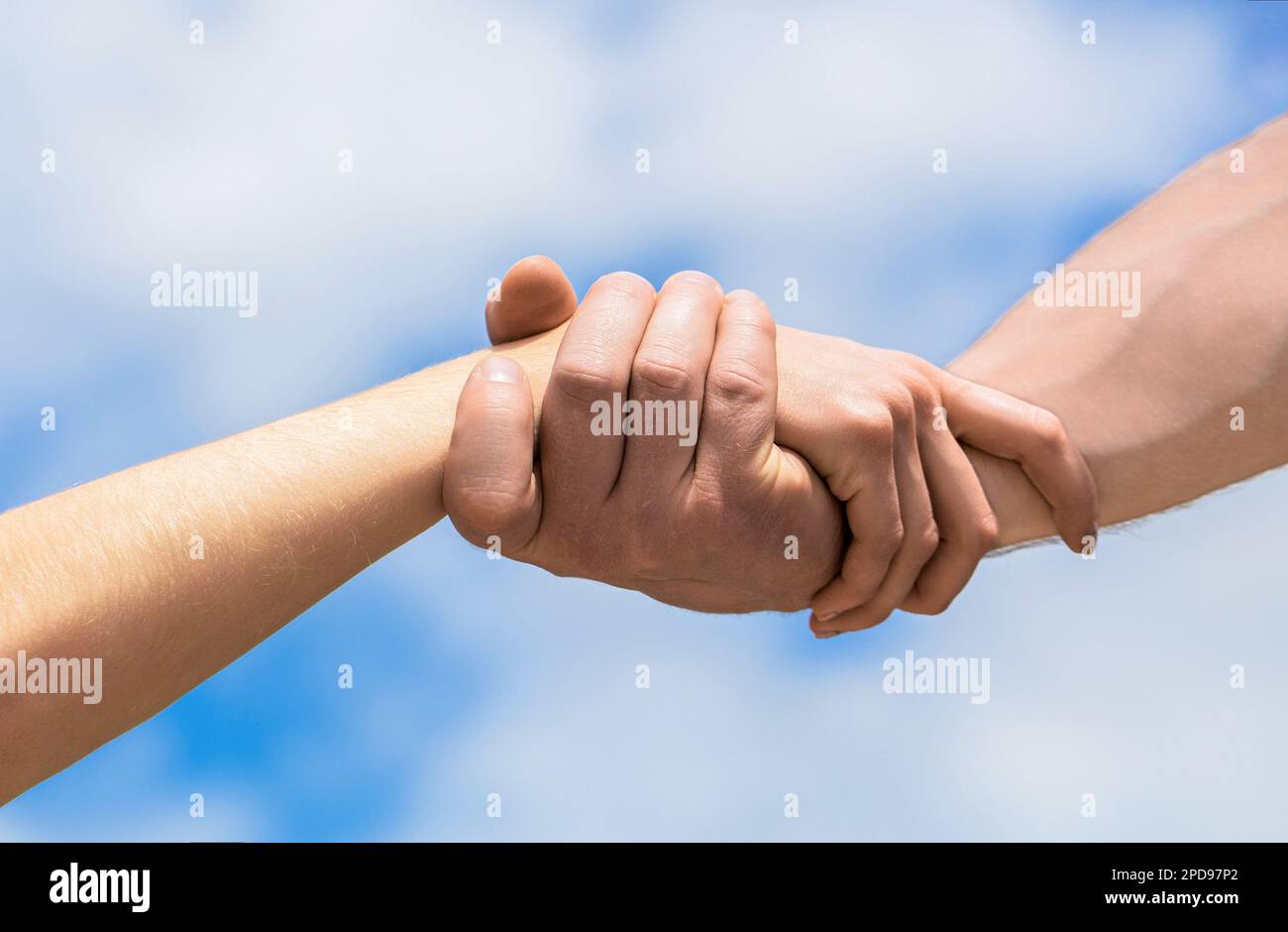 Giving a helping hand. Hands of man and woman on blue sky background ...