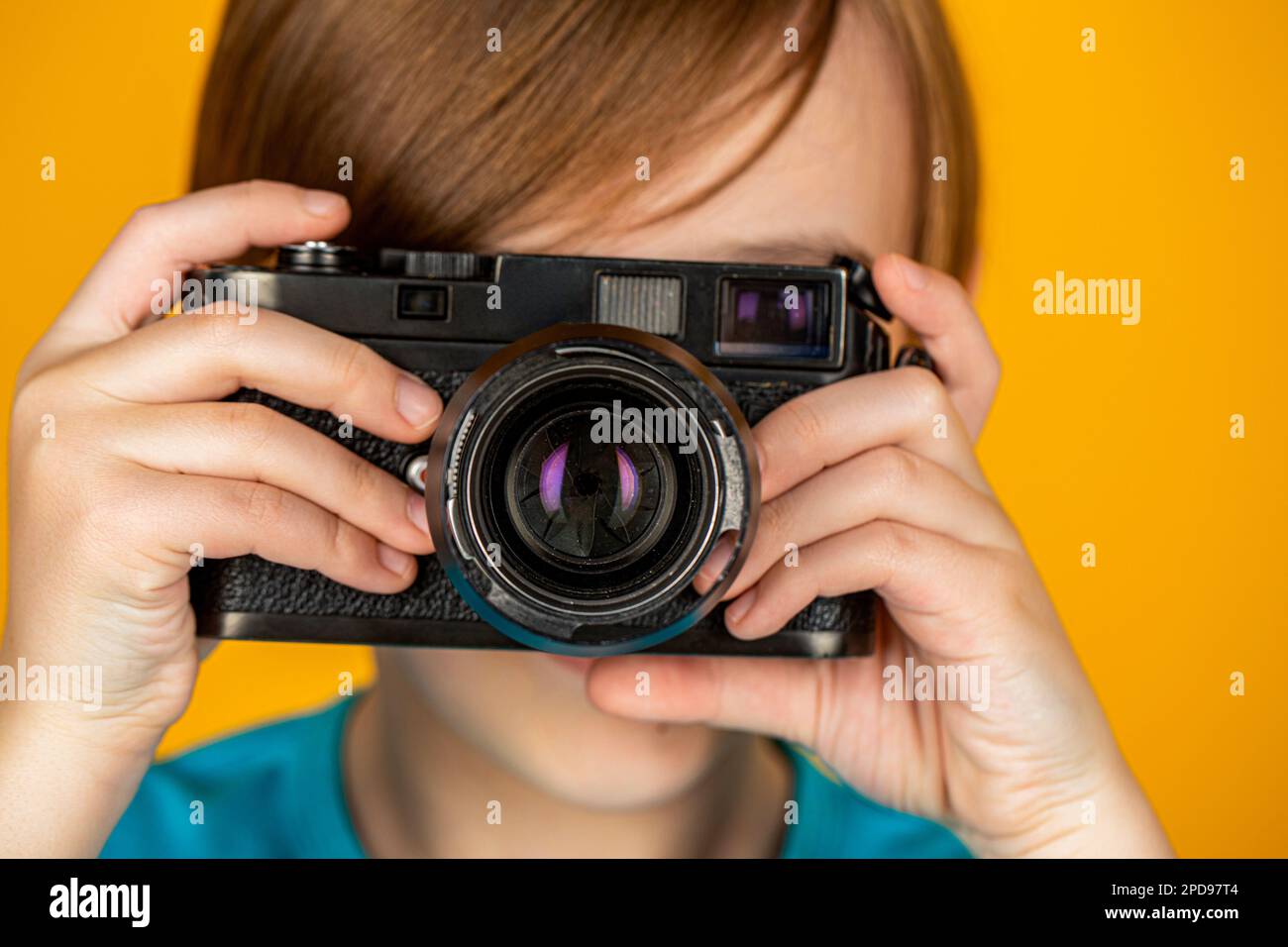 Child in studio with professional camera. Boy using a cameras. Baby boy ...