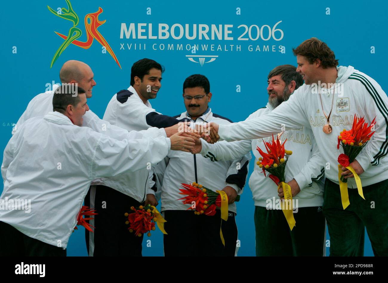 Players congratulate each other after the men's 10 meters Air Pistol ...