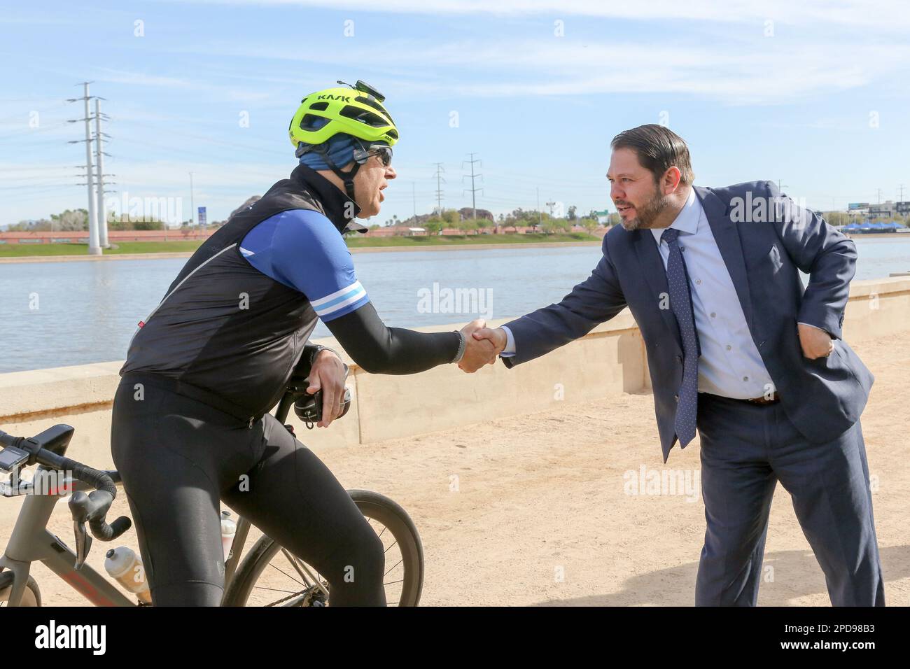 Arizona Senate candidate Ruben Gallego greets a passing cyclist after ...