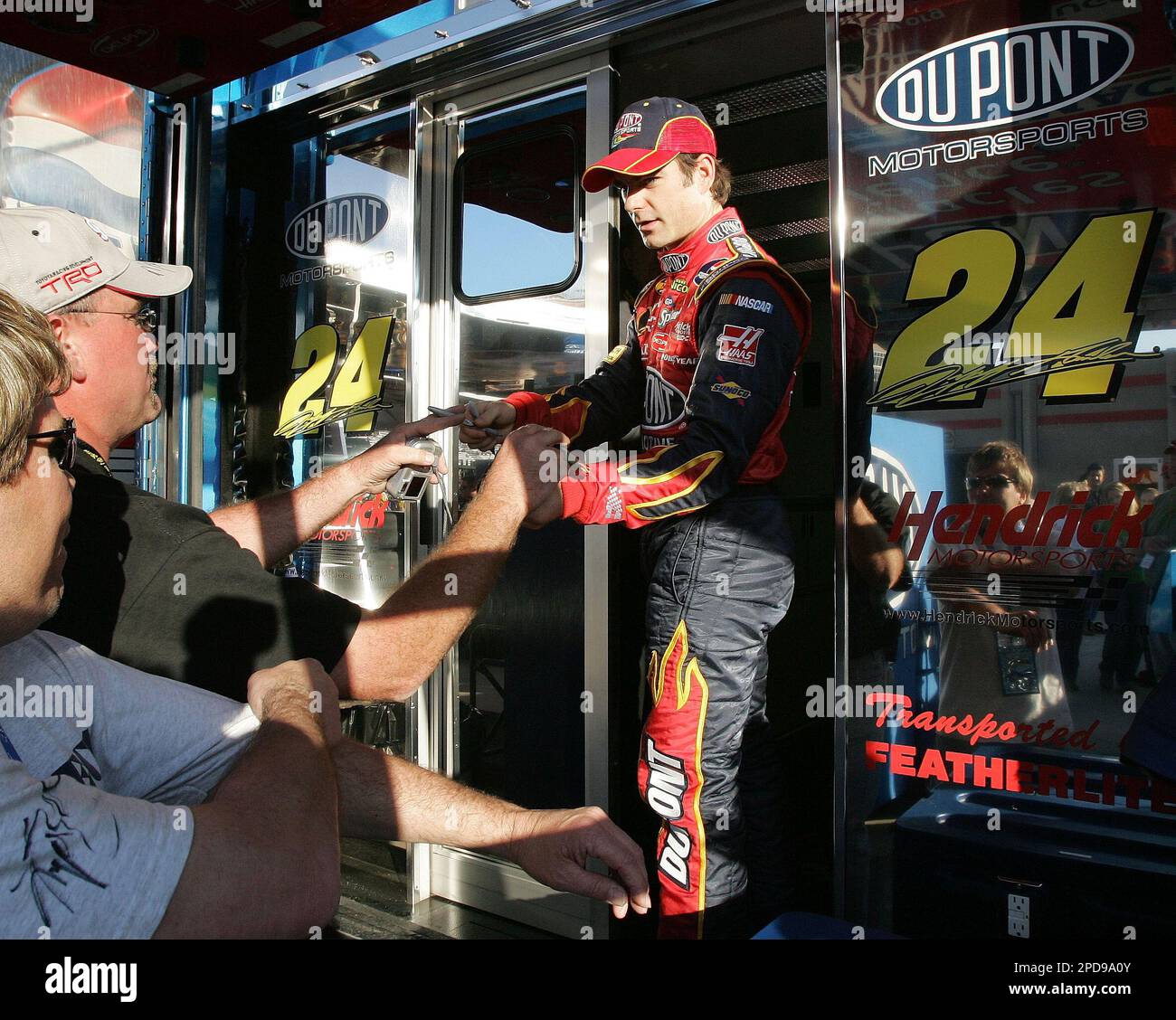 Jeff Gordon signs autographs at his car hauler during practice for the ...