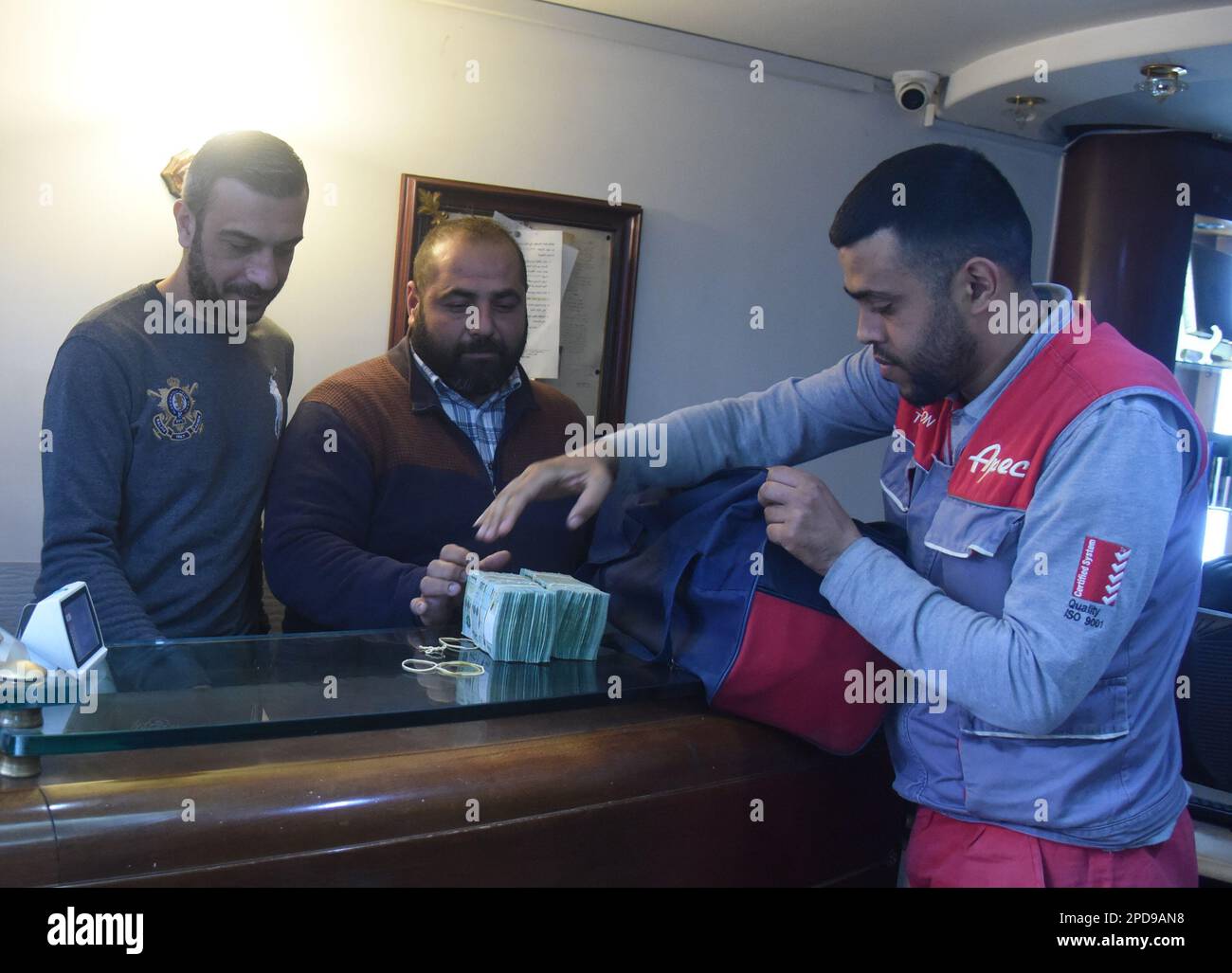 Tripoli, Lebanon. 14th Mar, 2023. A man puts stacks of Lebanese pound ...