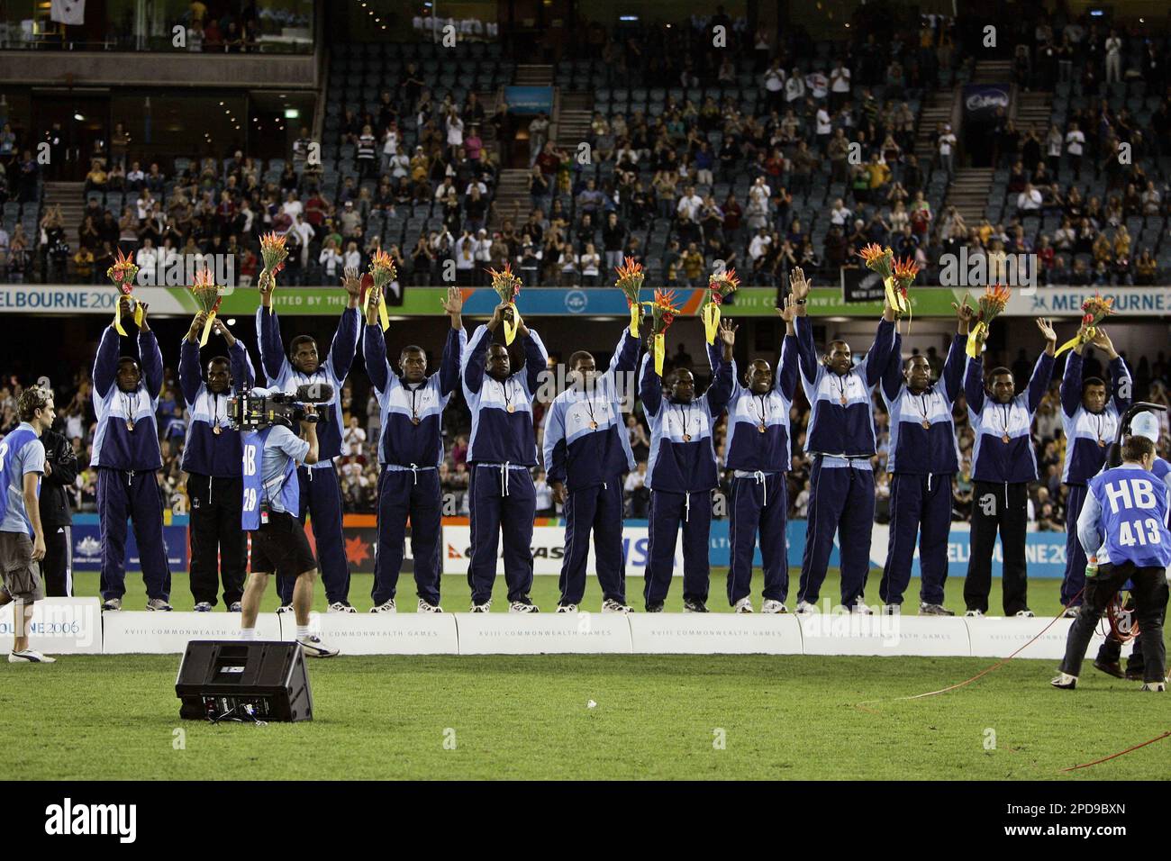 Members of Fiji's rugby team celebrate their bronze medal on the dias ...