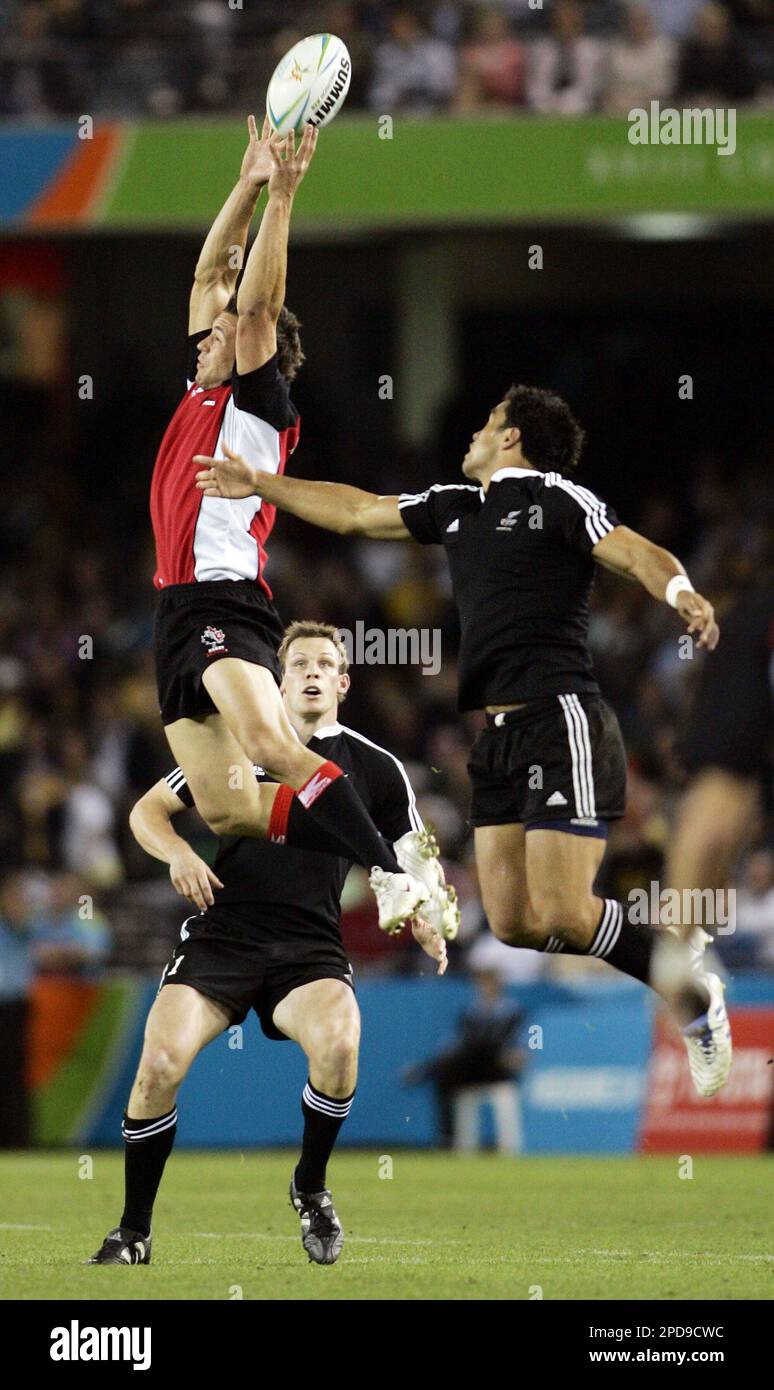 Canada's Brodie Henderson, left, jumps in an effort to secure the ball ...