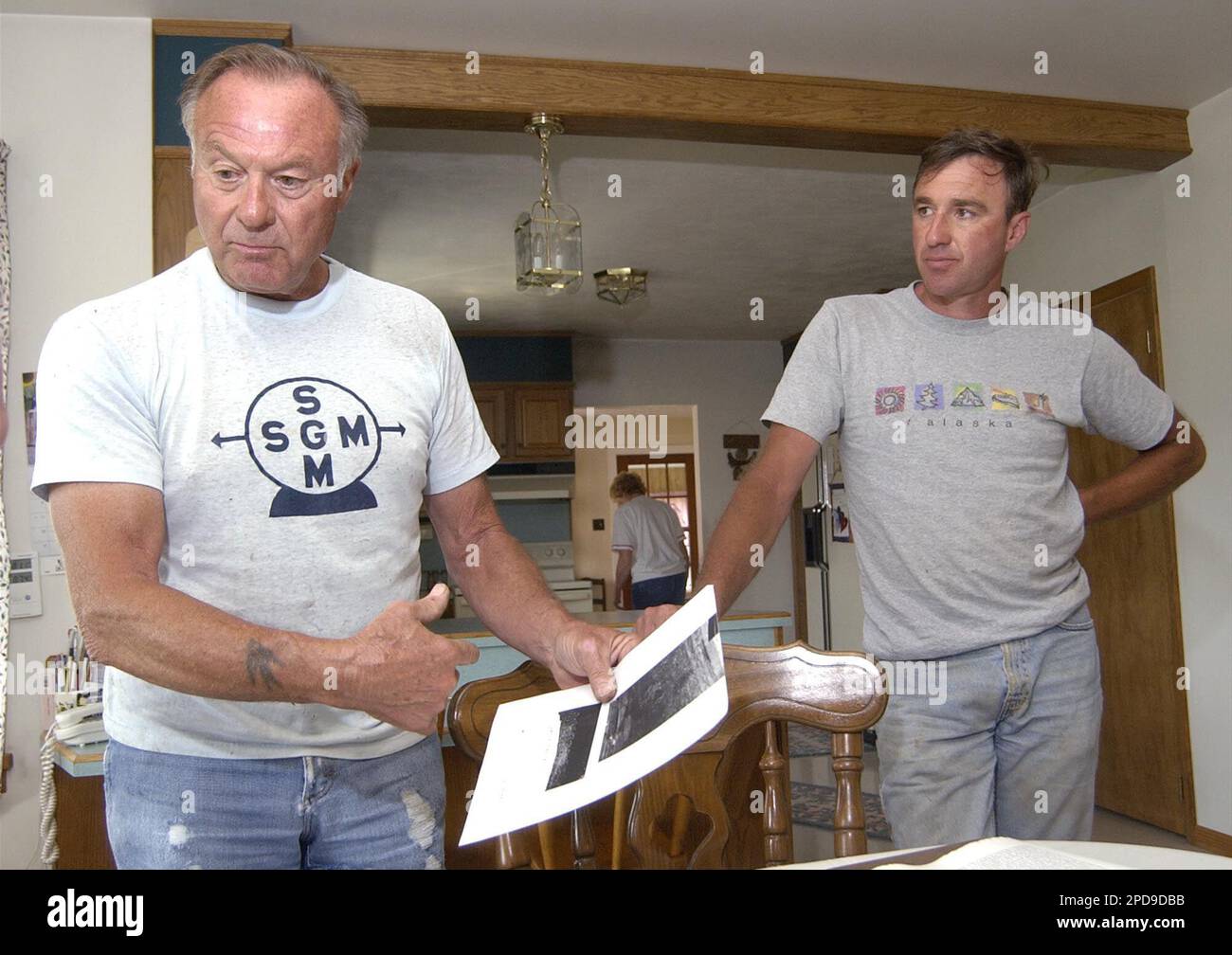 ** FILE ** Gerald E. Booher, left, and his son, David W. Booher talk ...