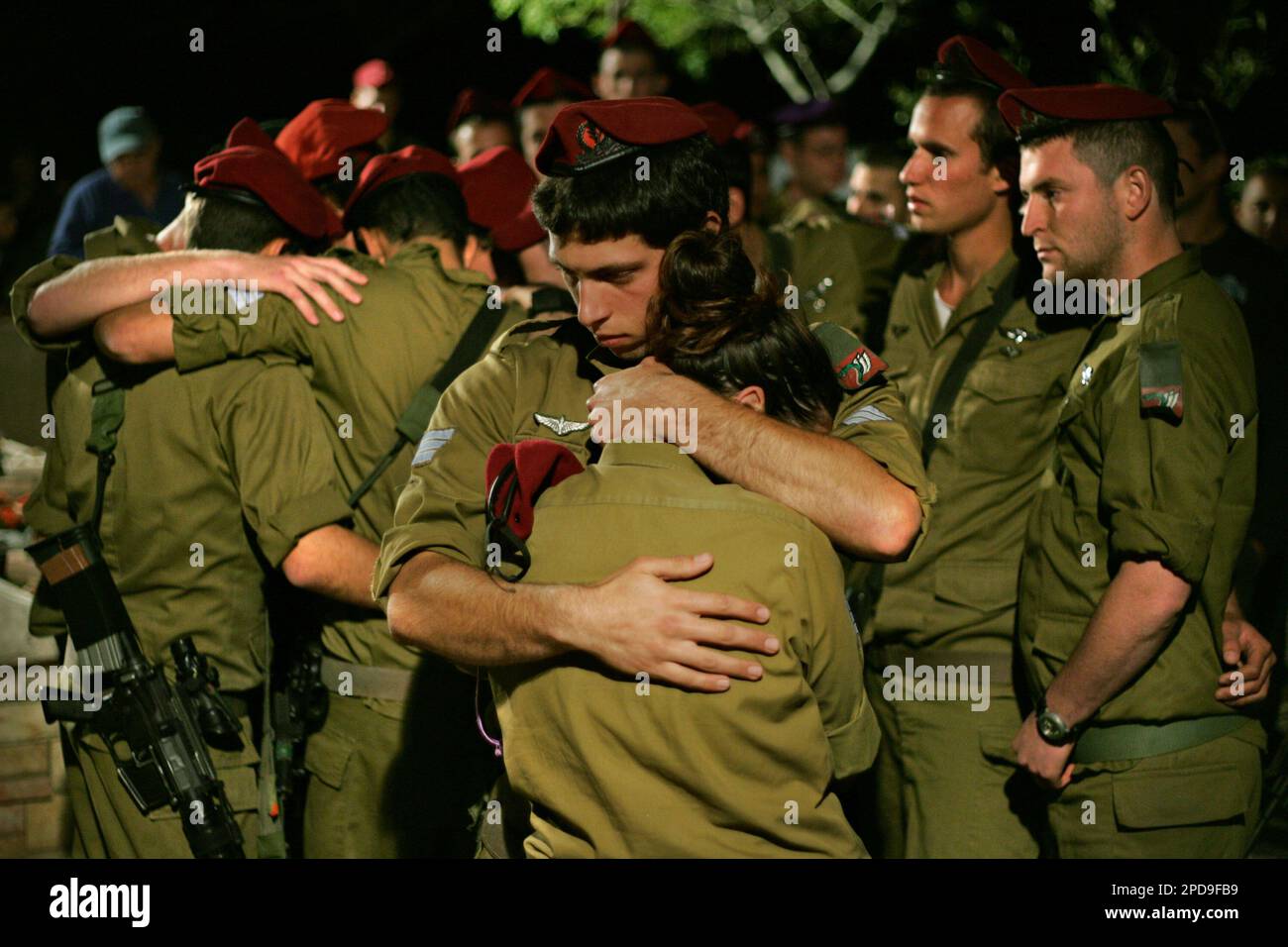 Israeli soldiers comfort each other during the funeral of Israeli army ...