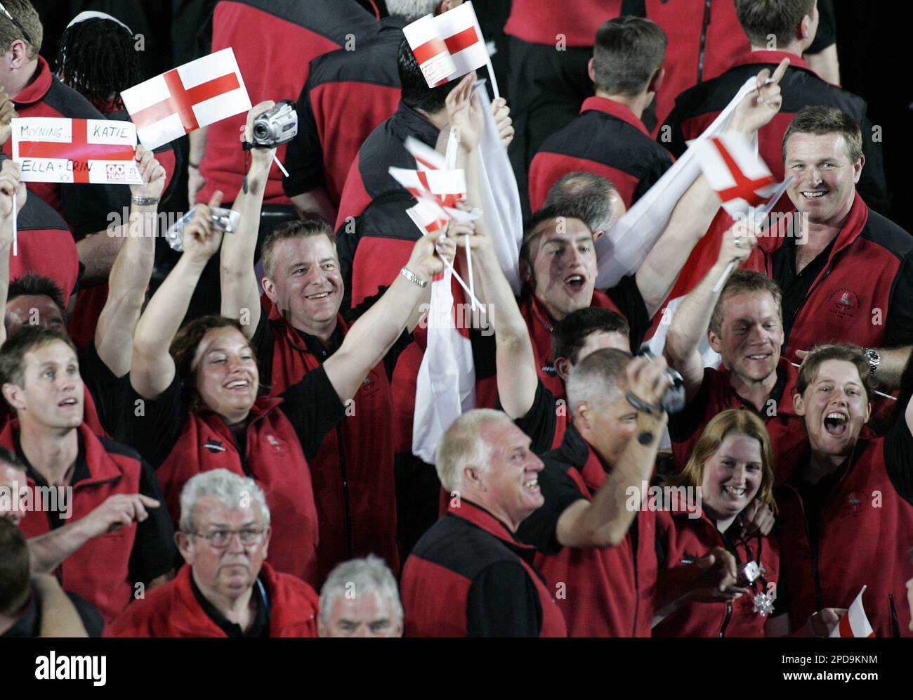 England's athletes wave as they enter the Melbourne Cricket Ground ...