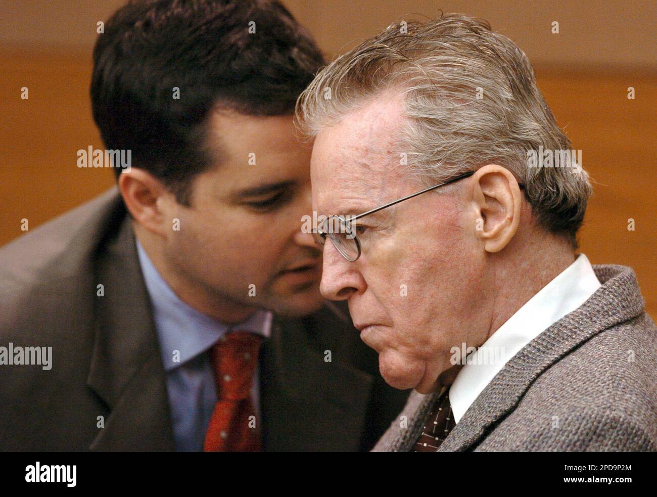 Attorney Josh Moore, left, speaks with his client, millionaire James ...