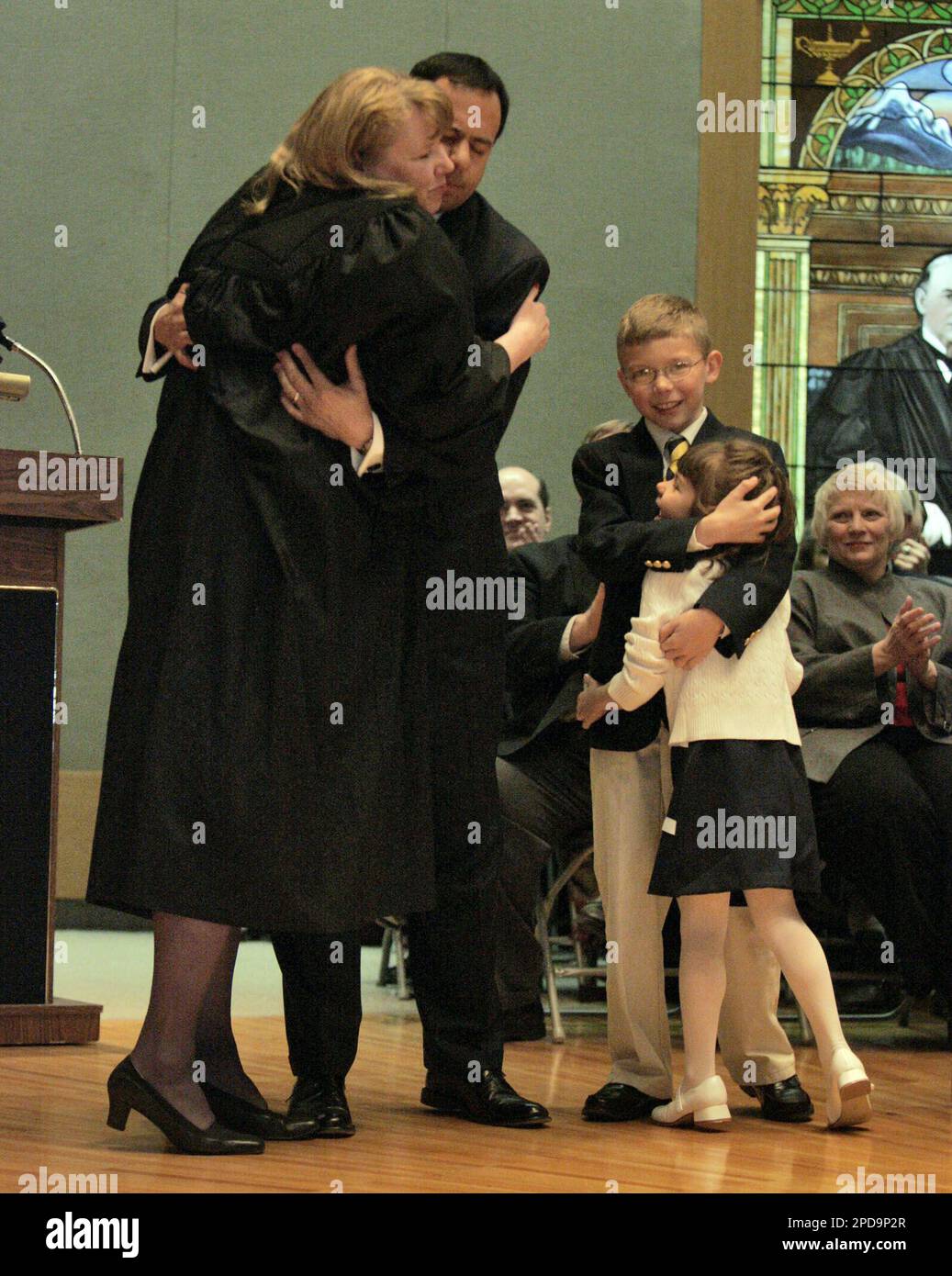 New Colorado Chief Justice Allison Eid is hugged by her husband, Troy ...