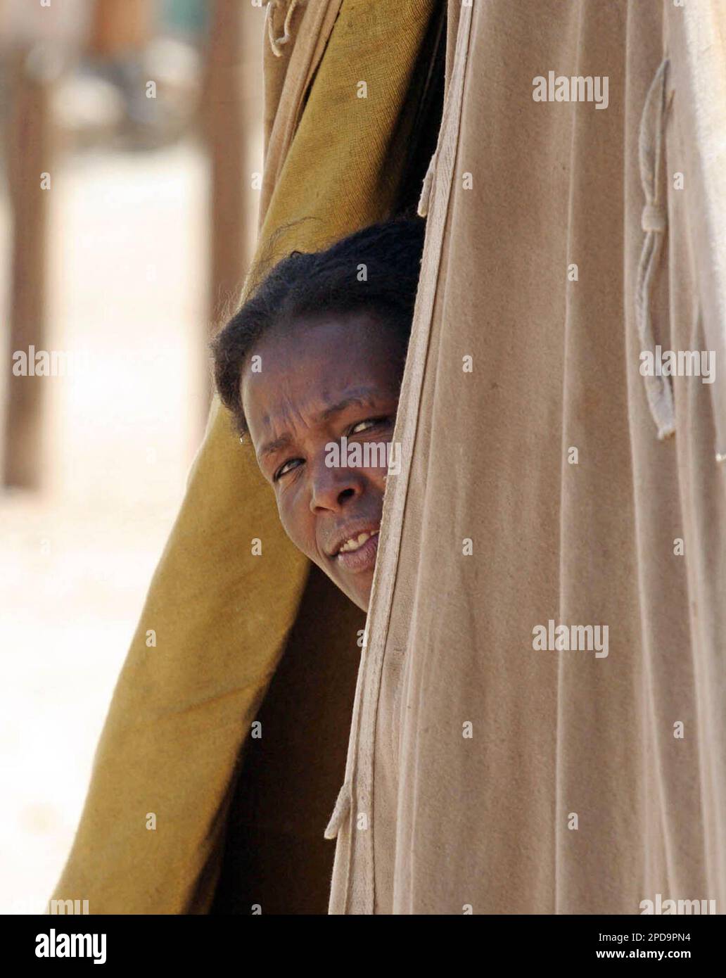 Genet Kidane sticks her head out of the family tent that she now calls ...