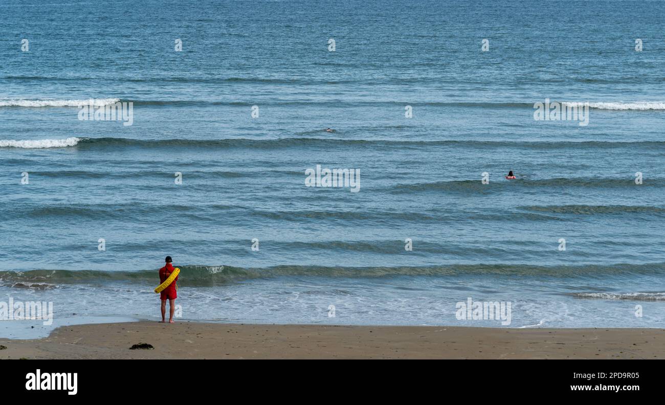 Lifeguard on duty at the edge on the beach. Swimmers safety and rescue ...
