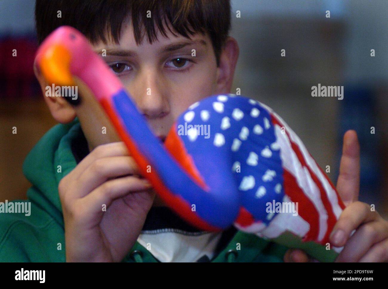 Joseph Anello, of Independence, Mo., paints a flamingo with an American ...