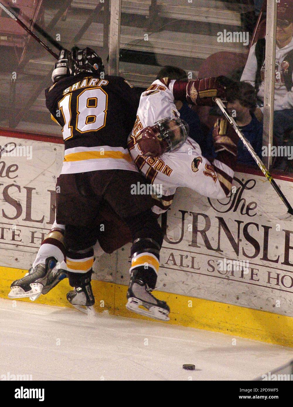 Minnesota Duluth's MacGregor Sharp checks Denver's Ryan Helgason in the ...