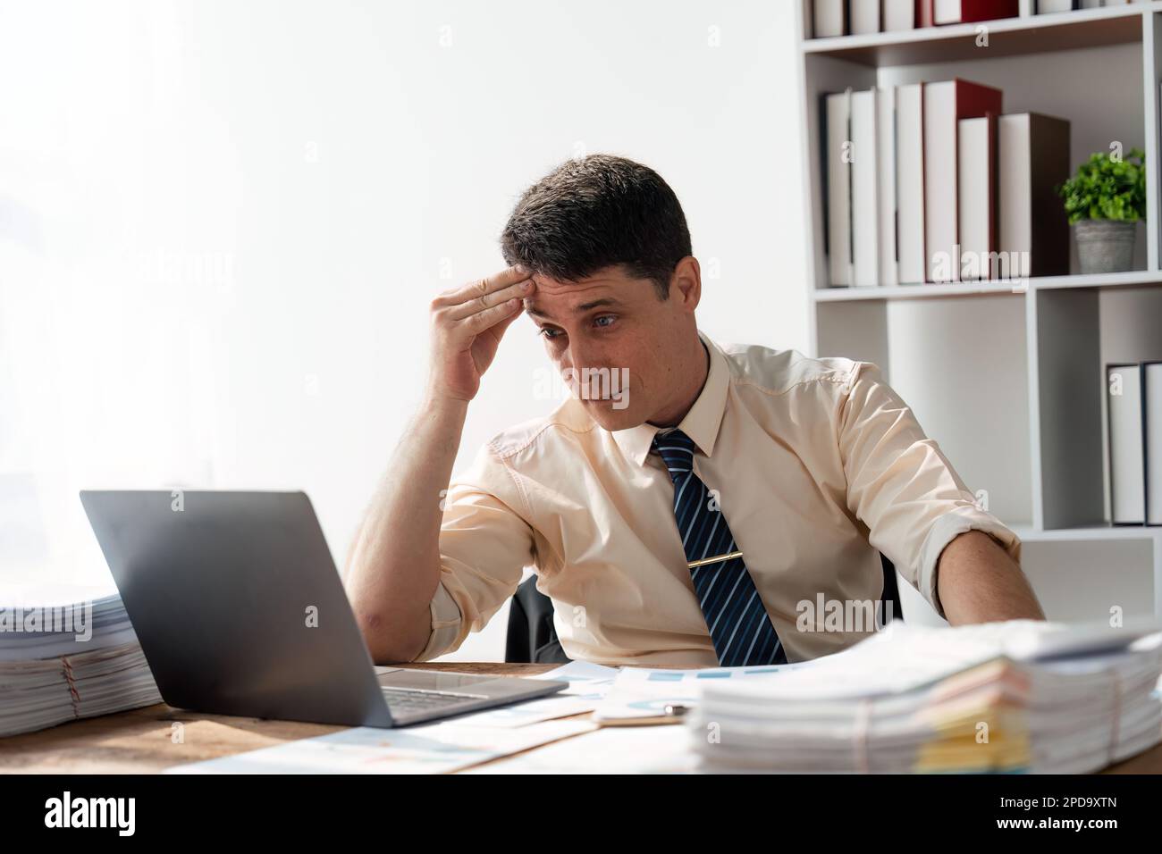 Serious businessman thinking hard of problem solution working in office ...