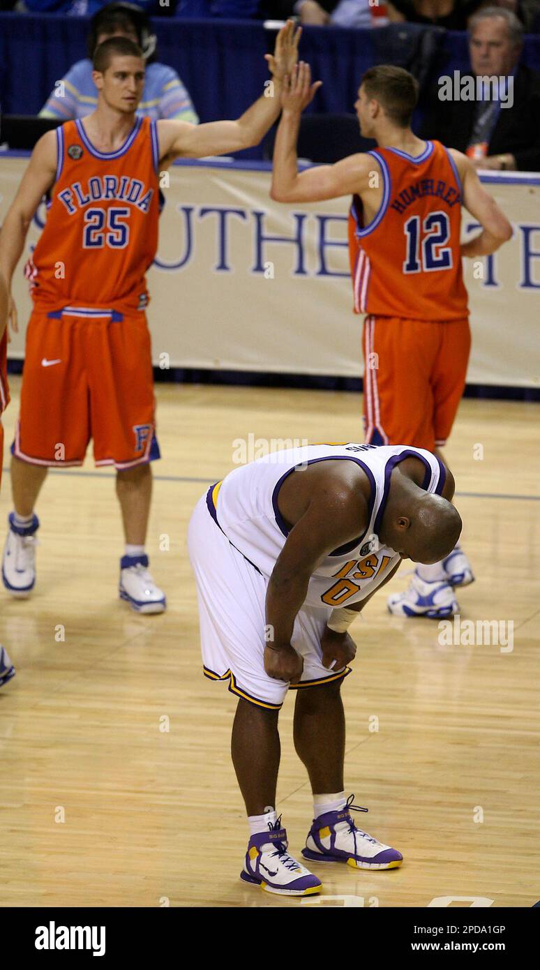 Louisiana State's Glen Davis, foreground, leans over on the court as ...